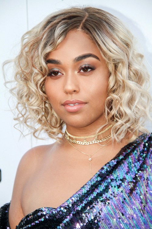 Jordyn Woods Curly Platinum Blonde Barrel Curls, Dark Roots Hairstyle ...